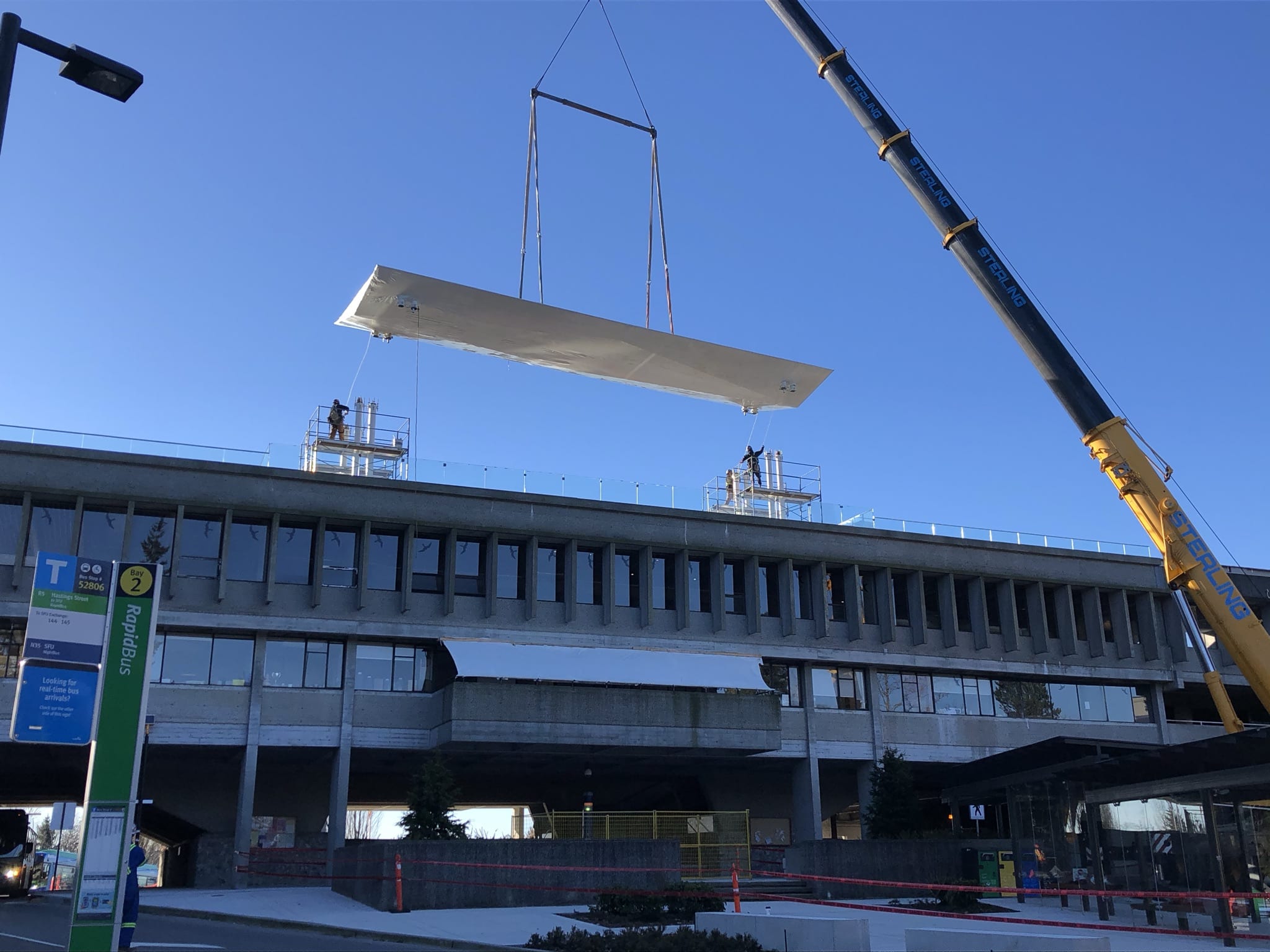New roof craned into SFU plaza - Fast + Epp